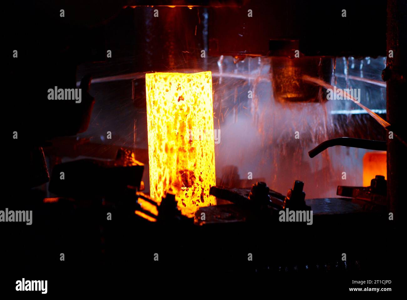 metal forging. hydraulic hammer shapes the red hot billet. the ...