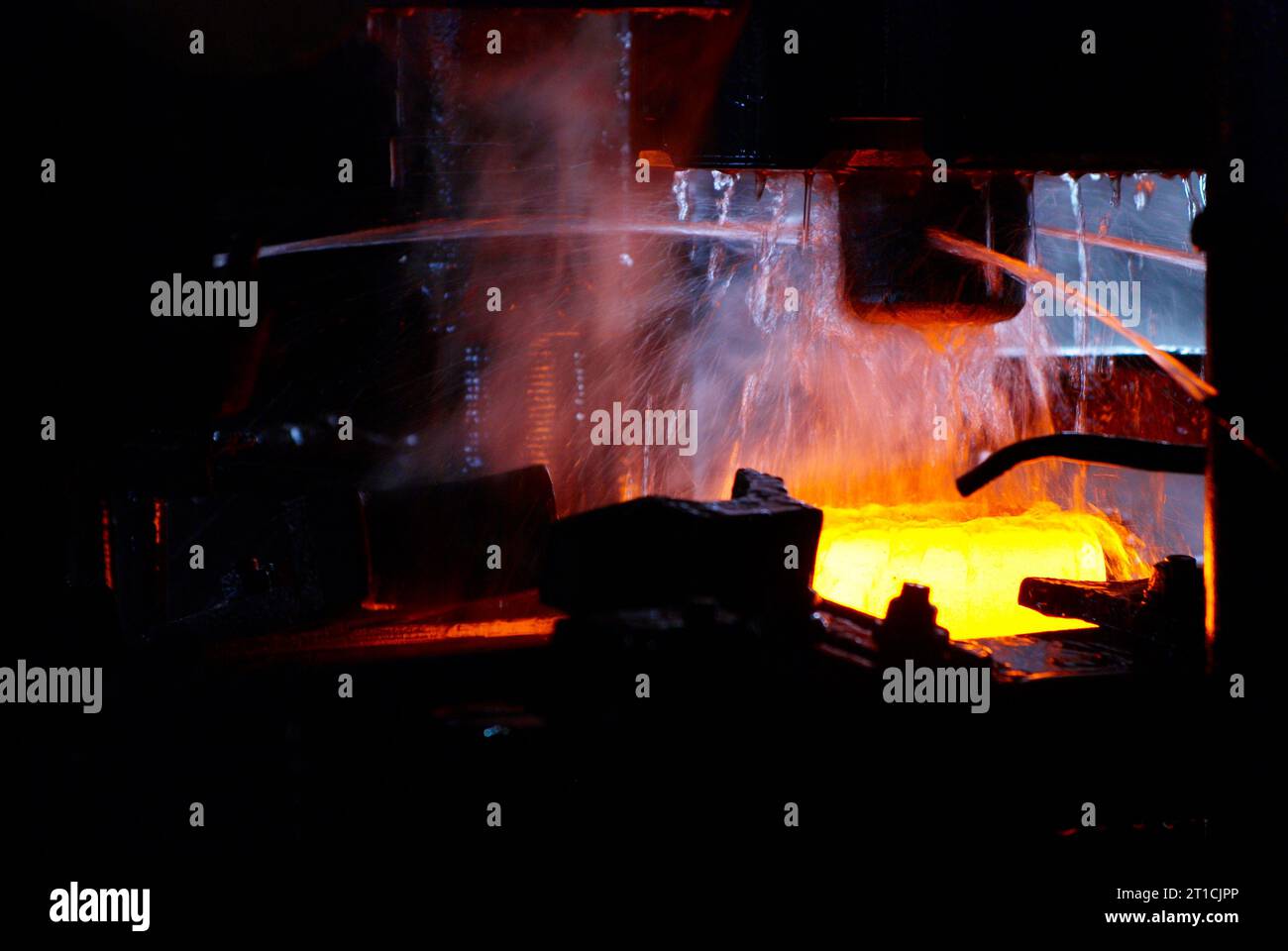 metal forging. hydraulic hammer shapes the red hot billet. the ...