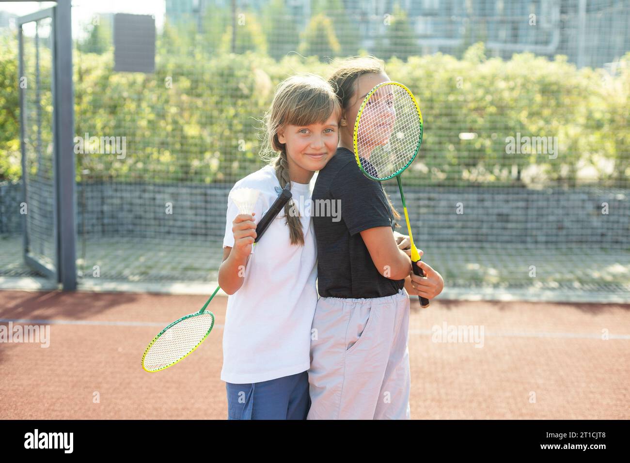 Happy sporty elementary school age girl, child playing badminton ...