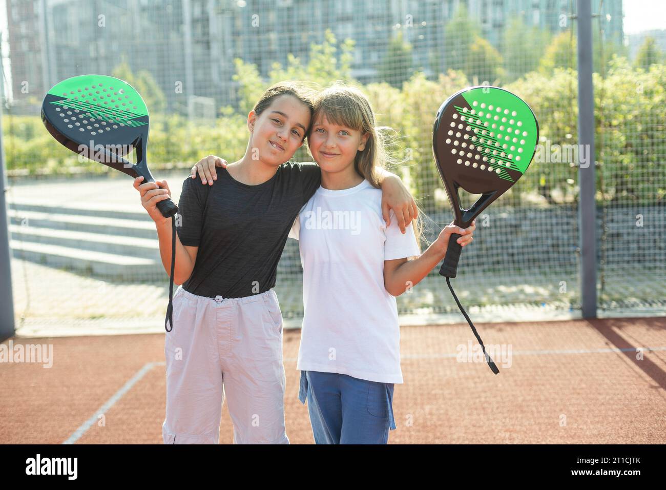 Kids and sports concept. Portrait of smiling girls posing outdoor on ...
