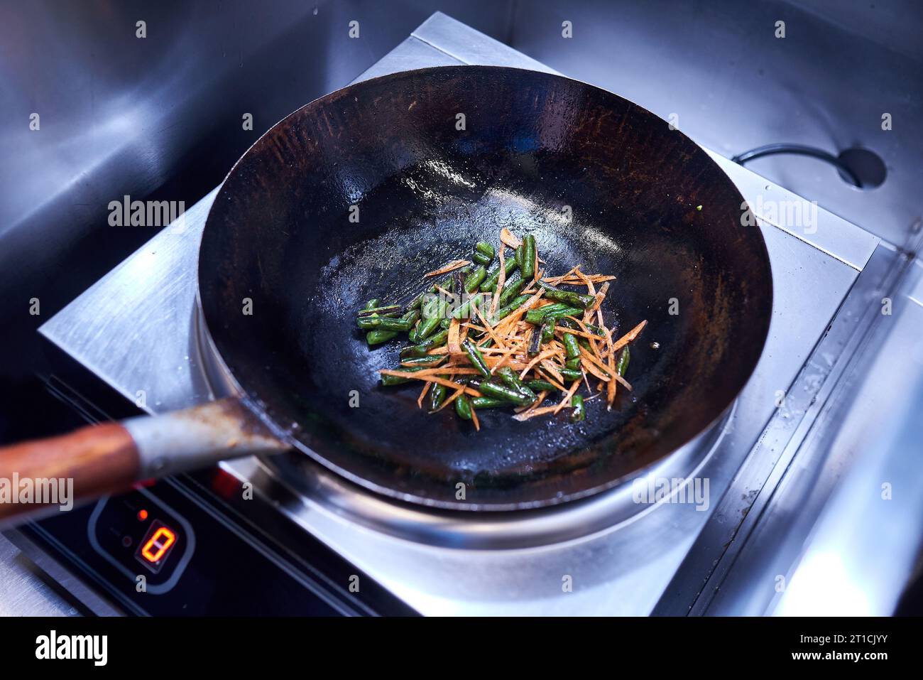 cooking process fried noodles with vegetables in the wok, traditional ...