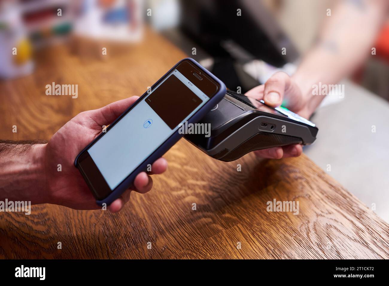 Customer paying by smartphone with NFC technology Stock Photo - Alamy