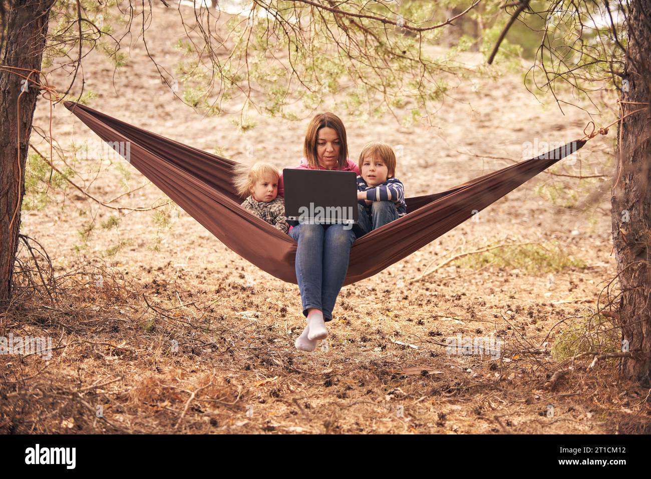 Working away from office concept, man working on laptop while lying in ...