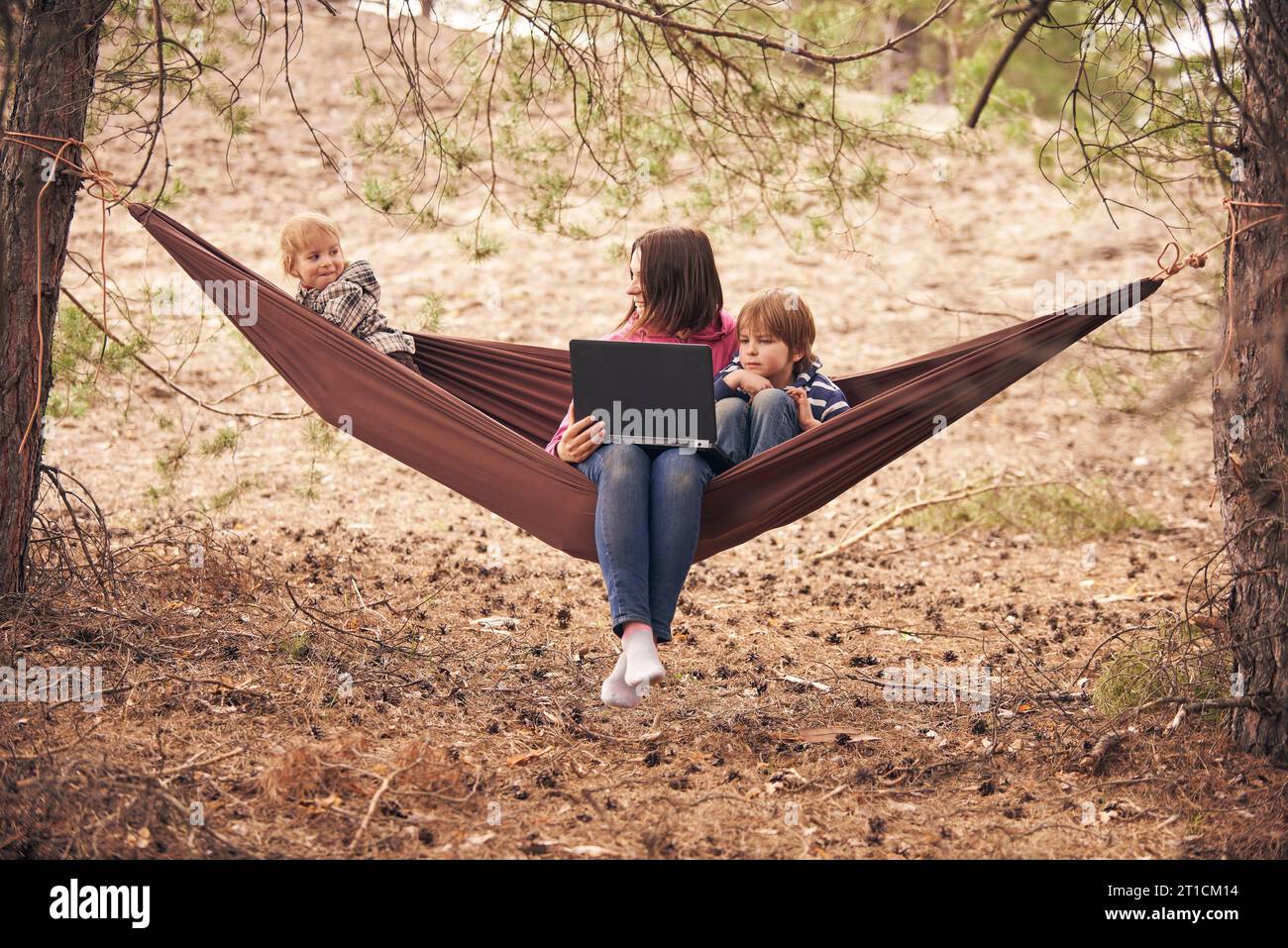 Working away from office concept, man working on laptop while lying in ...