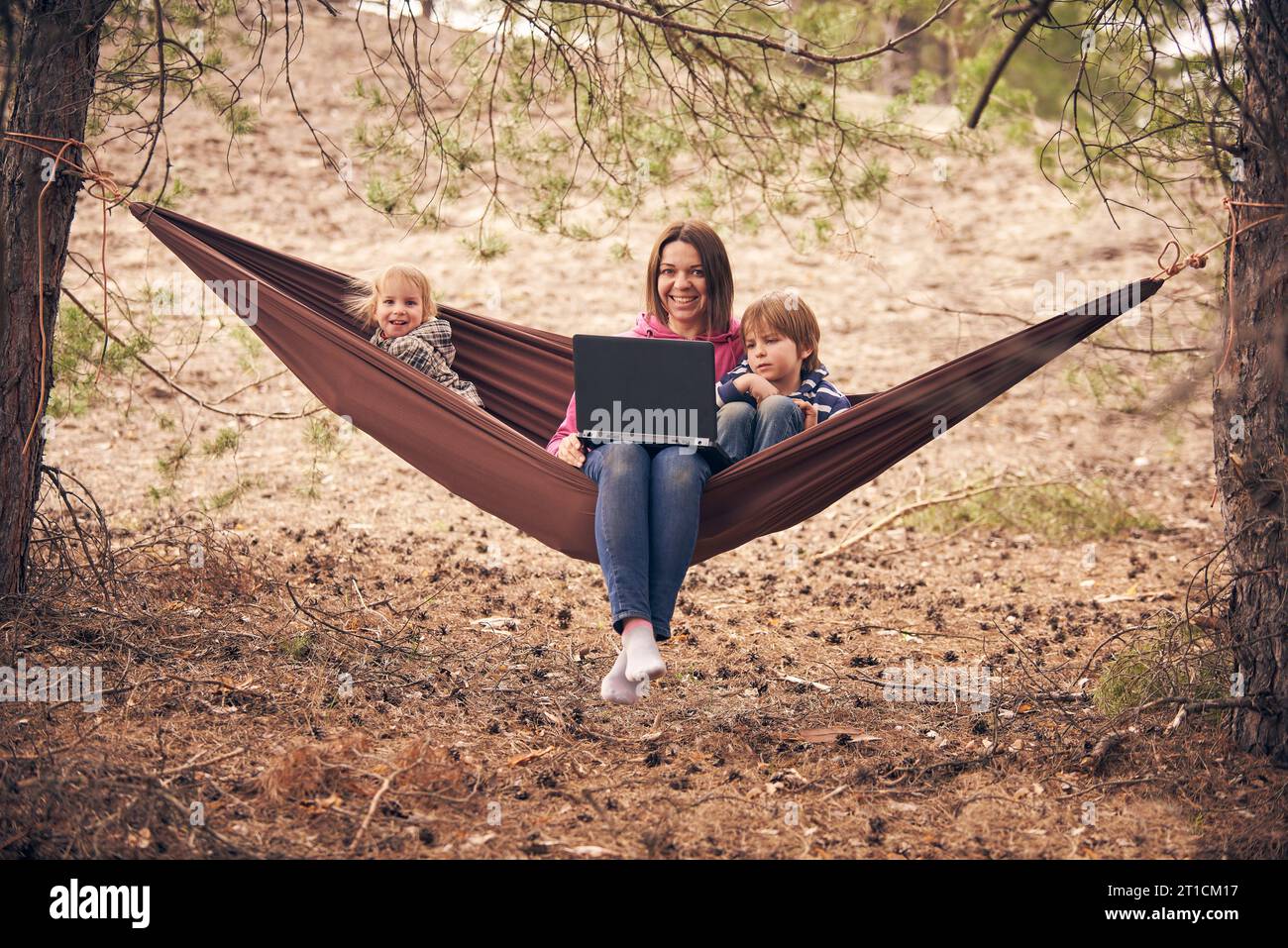 Working away from office concept, man working on laptop while lying in ...