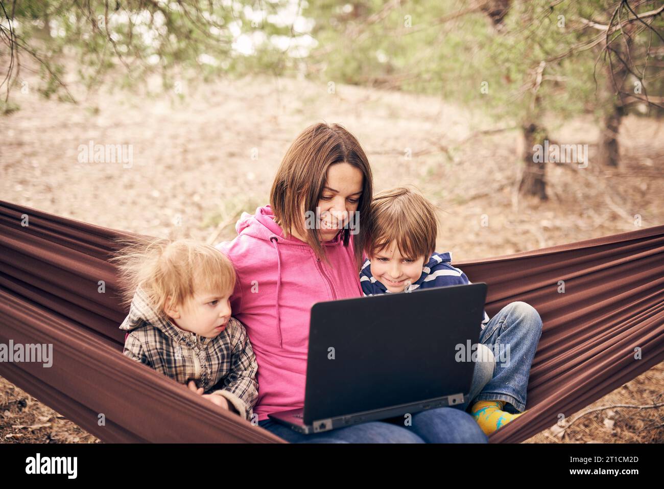 Working away from office concept, man working on laptop while lying in ...