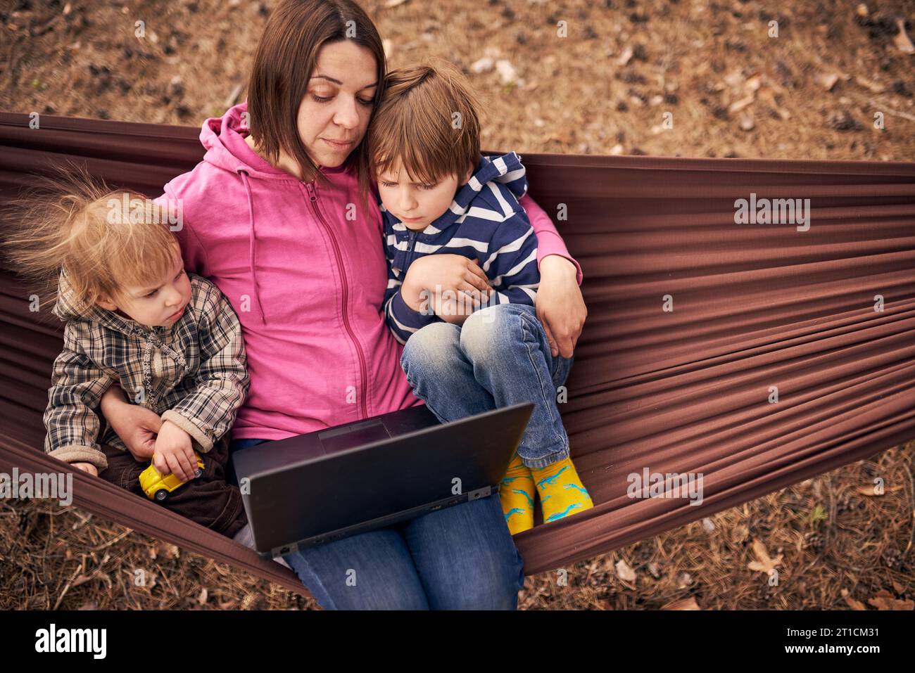 Working away from office concept, man working on laptop while lying in ...