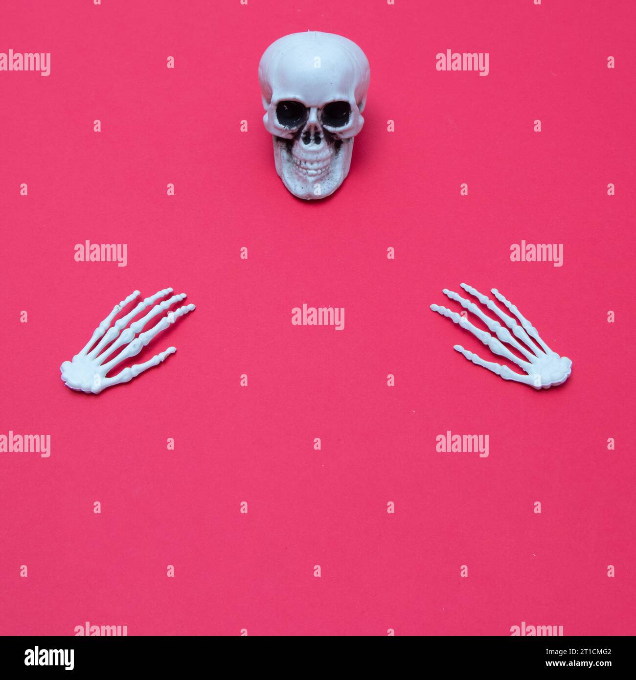 Skull and skeleton hands on red background ready for Halloween, with ...