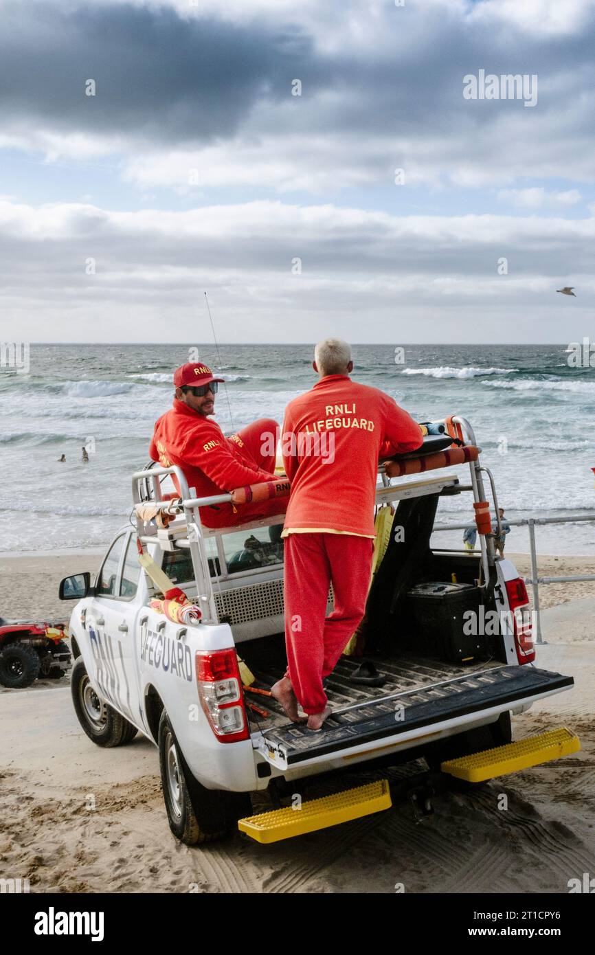 Two RNLI Lifeguards on their emergency response vehicle on duty at ...
