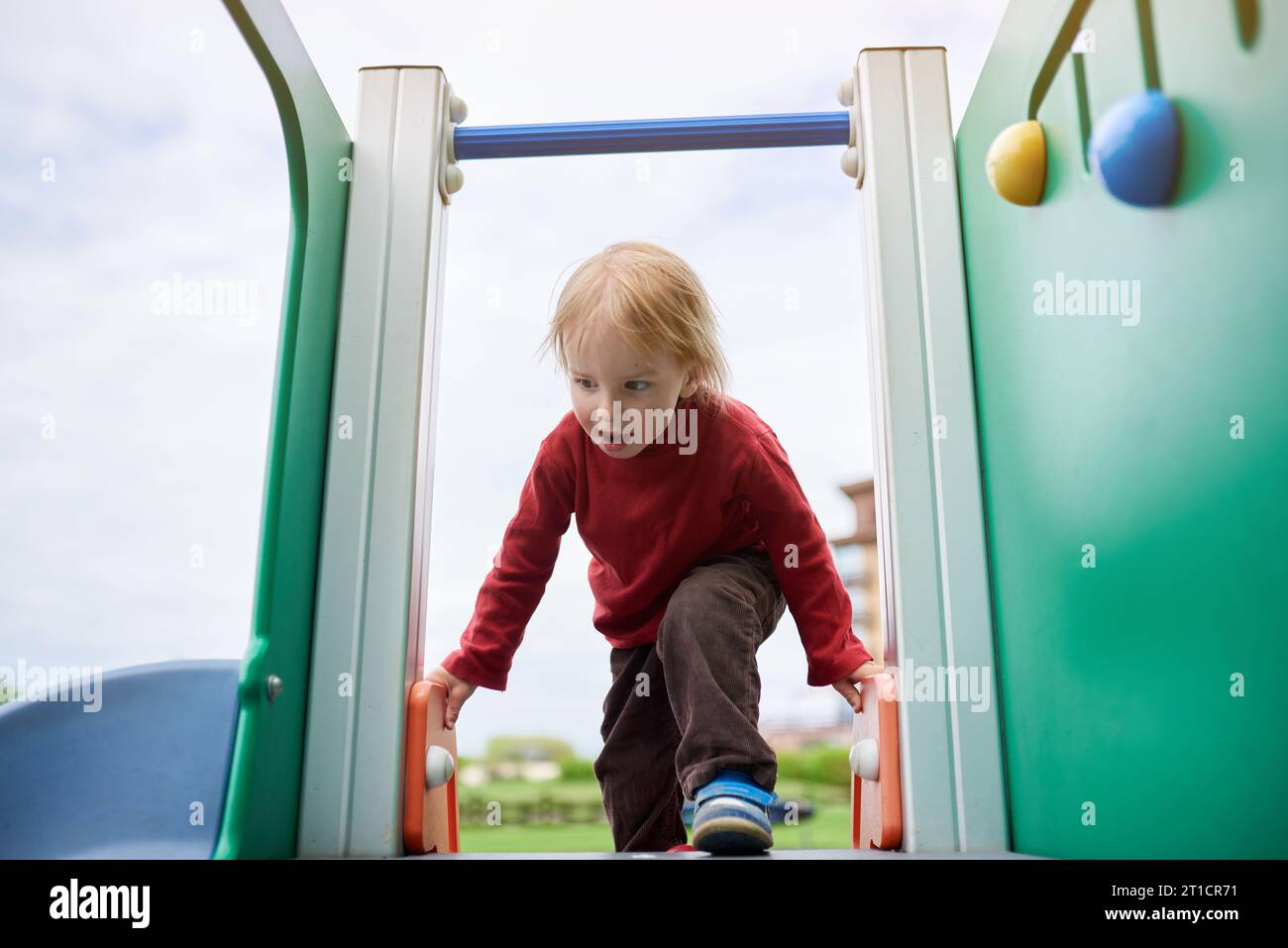 Happy 2 year old toddler playing at the playground Stock Photo - Alamy