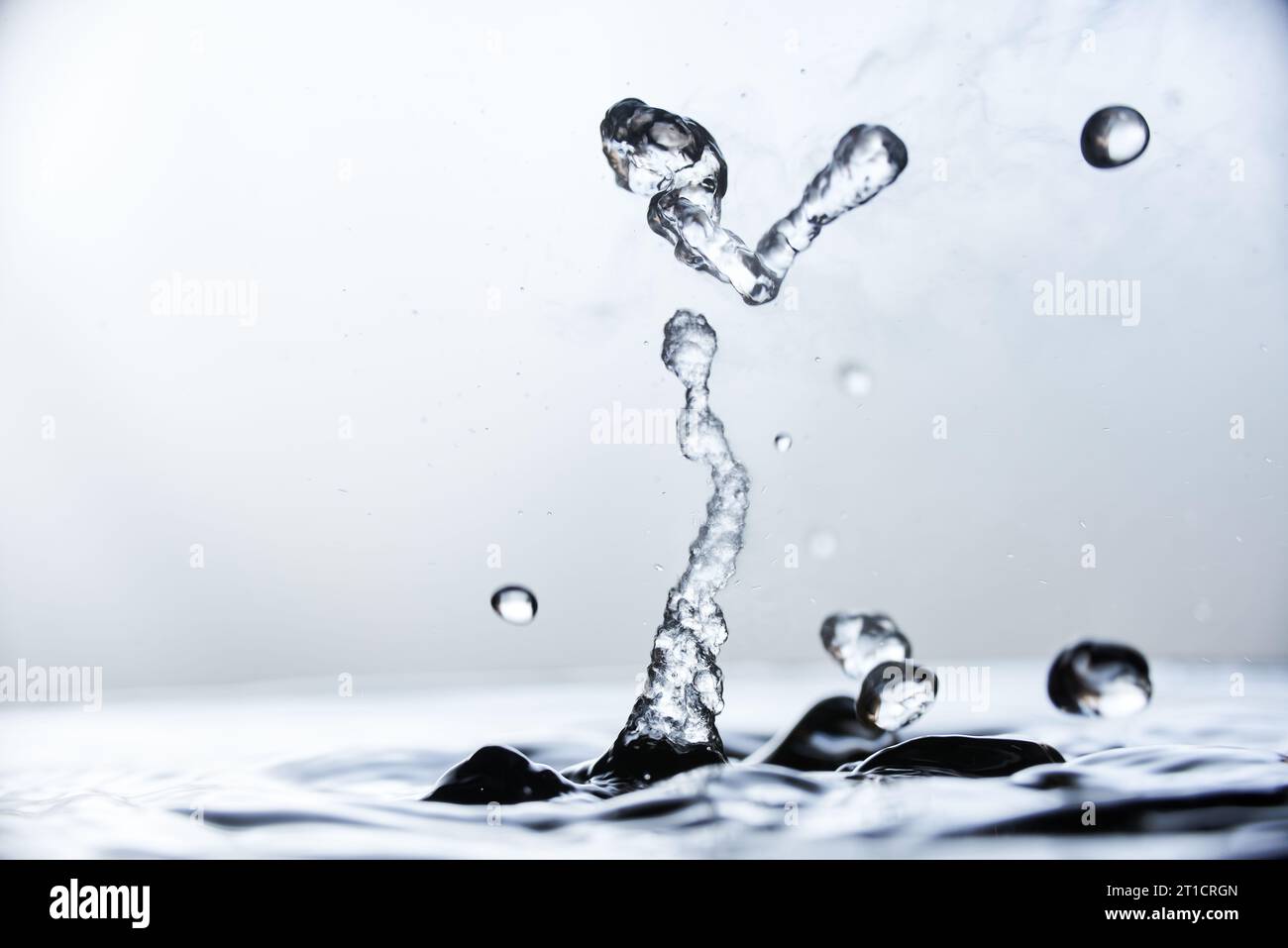 Boiling water splash with steam on blue background closeup Stock Photo ...