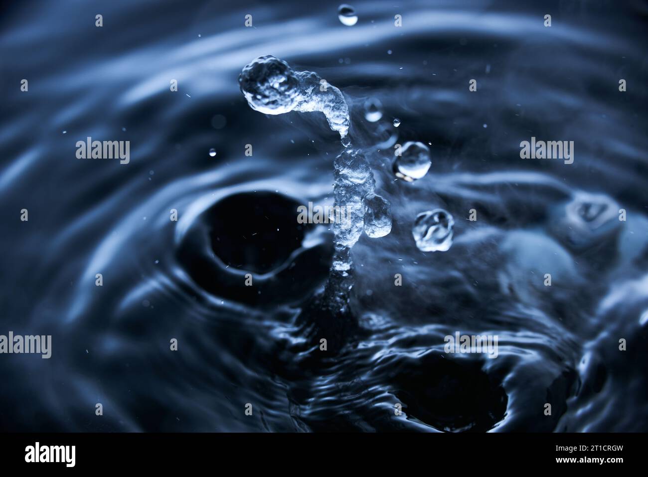 Boiling water splash with steam on dark blue background closeup Stock ...