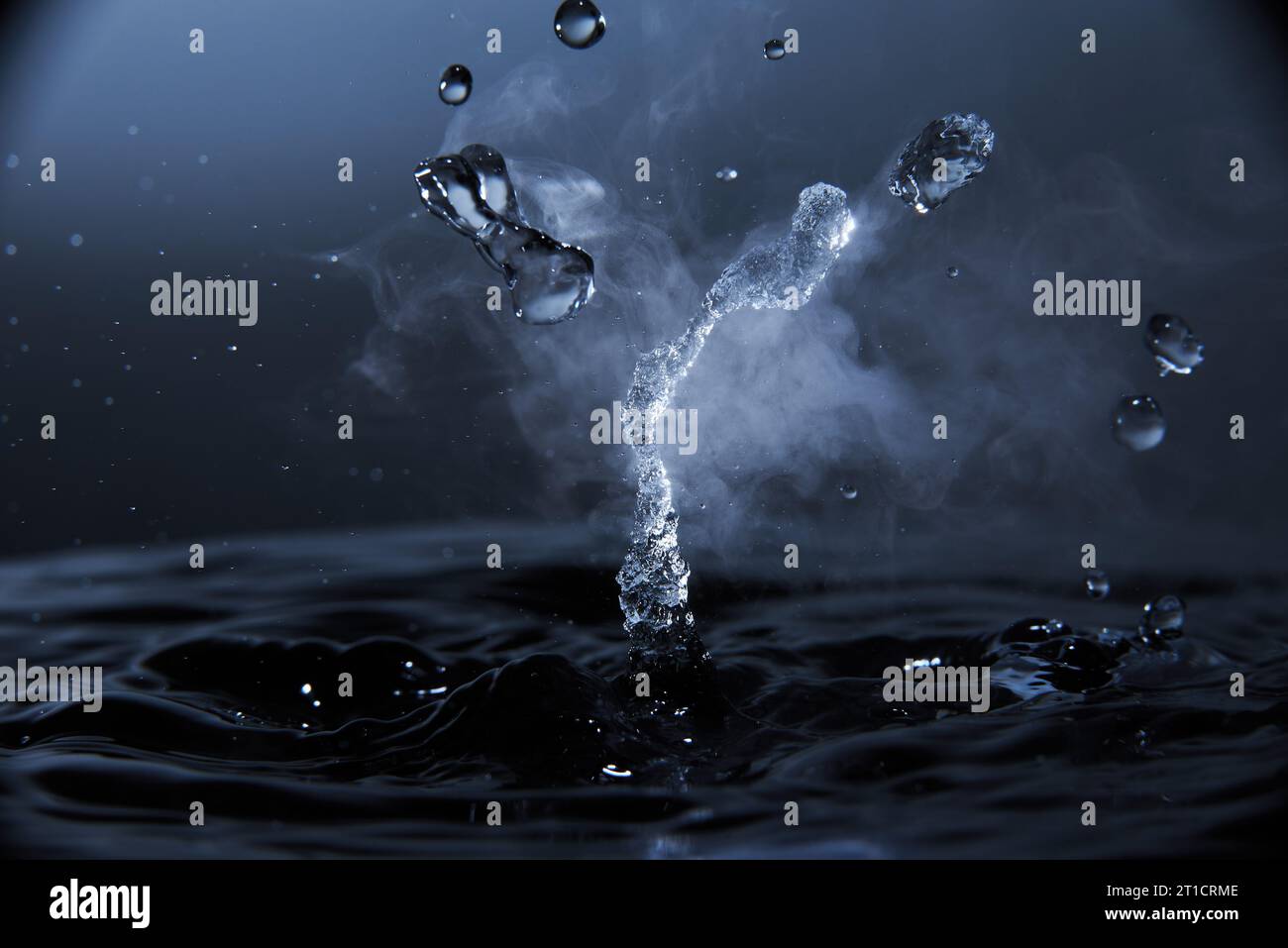 Boiling water splash with steam on dark blue background closeup Stock ...