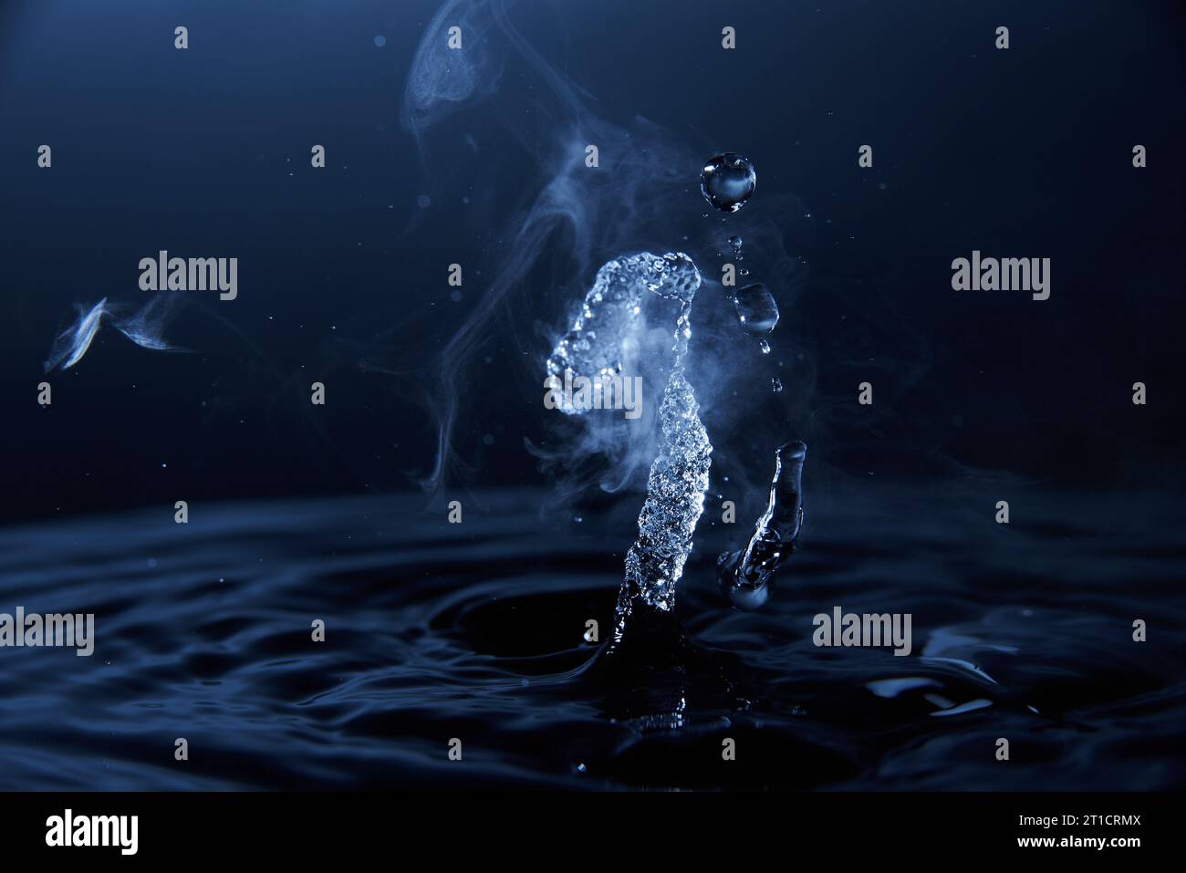 Boiling water splash with steam on dark blue background closeup Stock ...