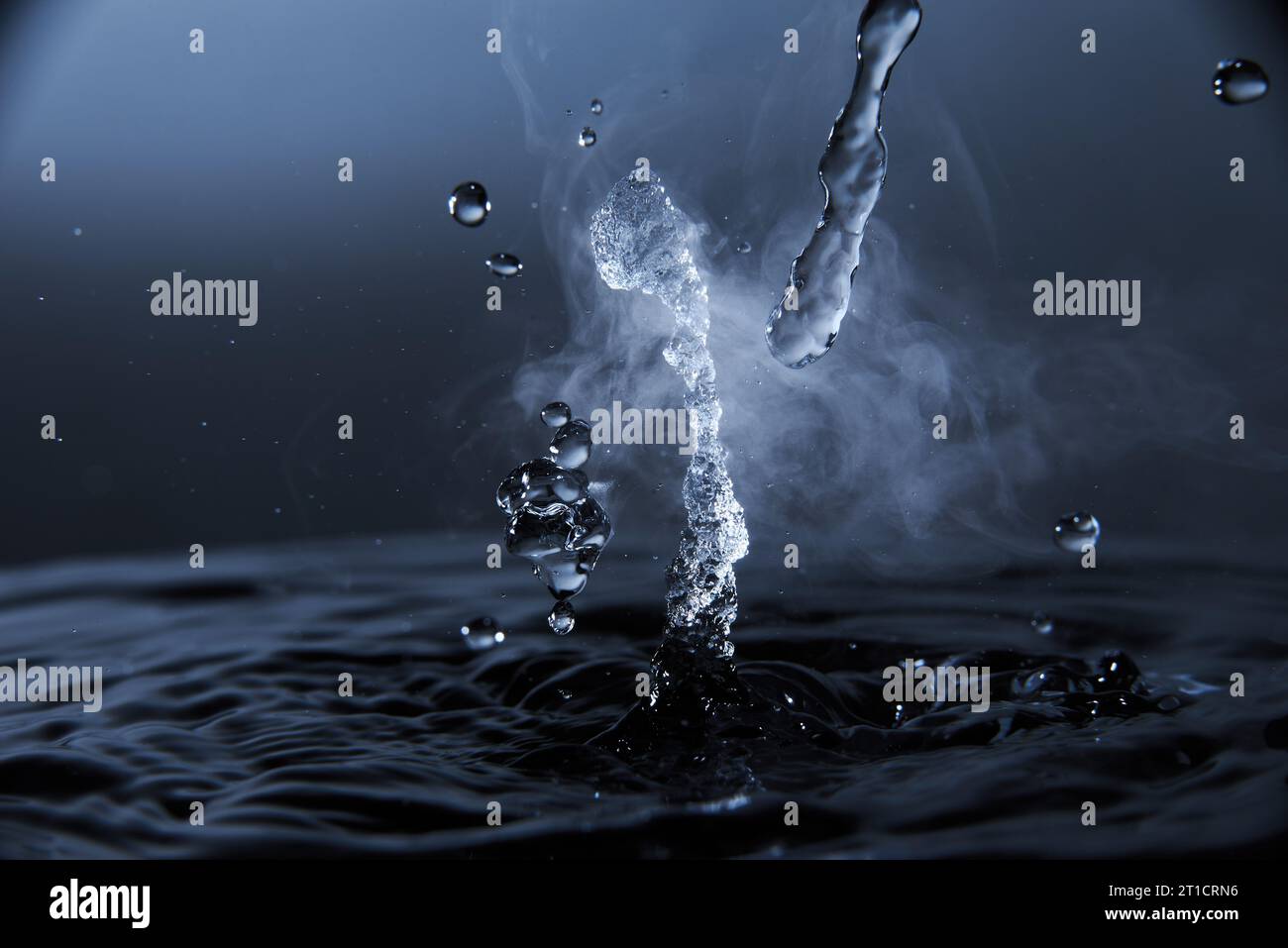 Boiling water splash with steam on dark blue background closeup Stock ...