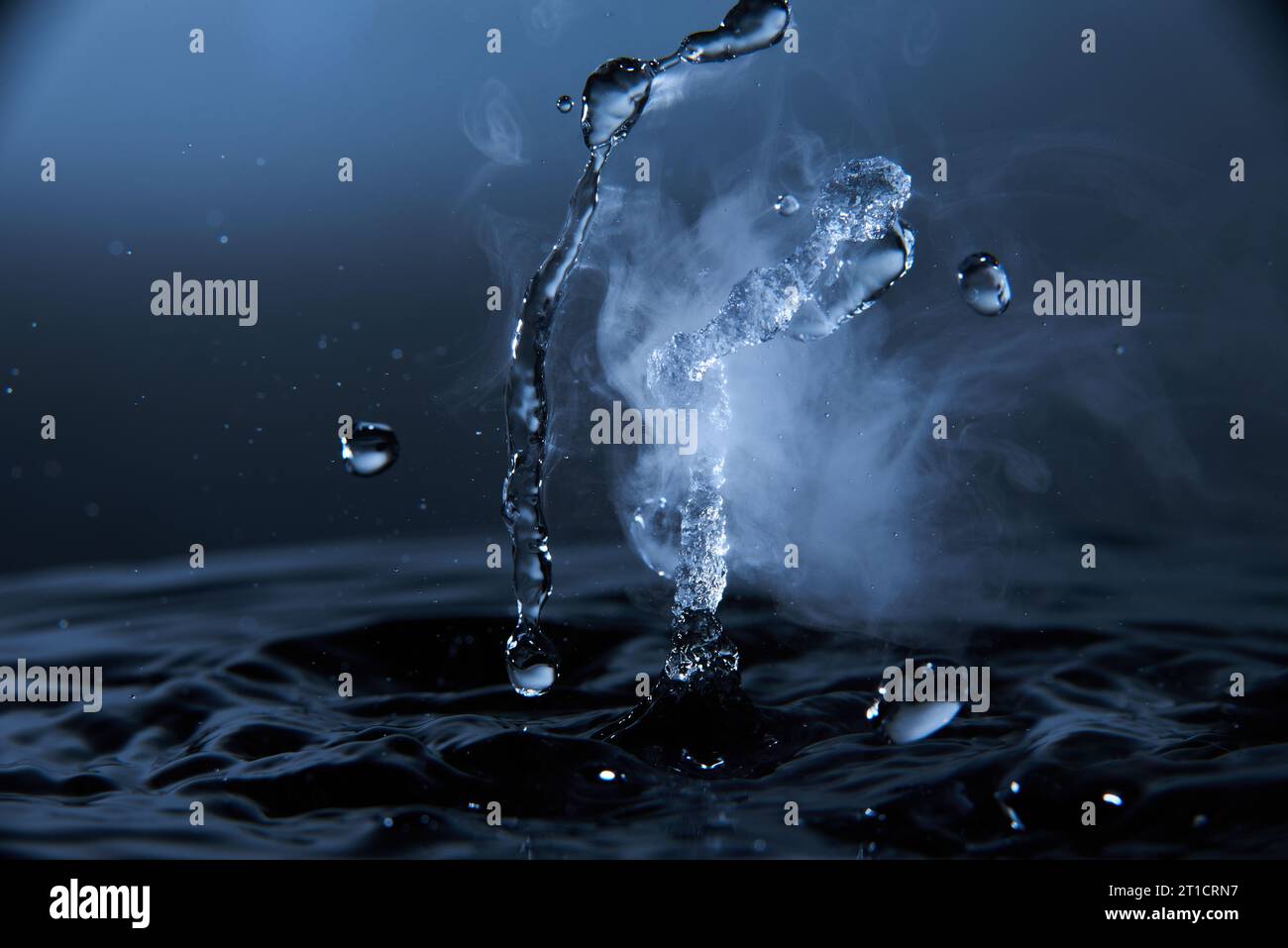 Boiling water splash with steam on dark blue background closeup Stock ...