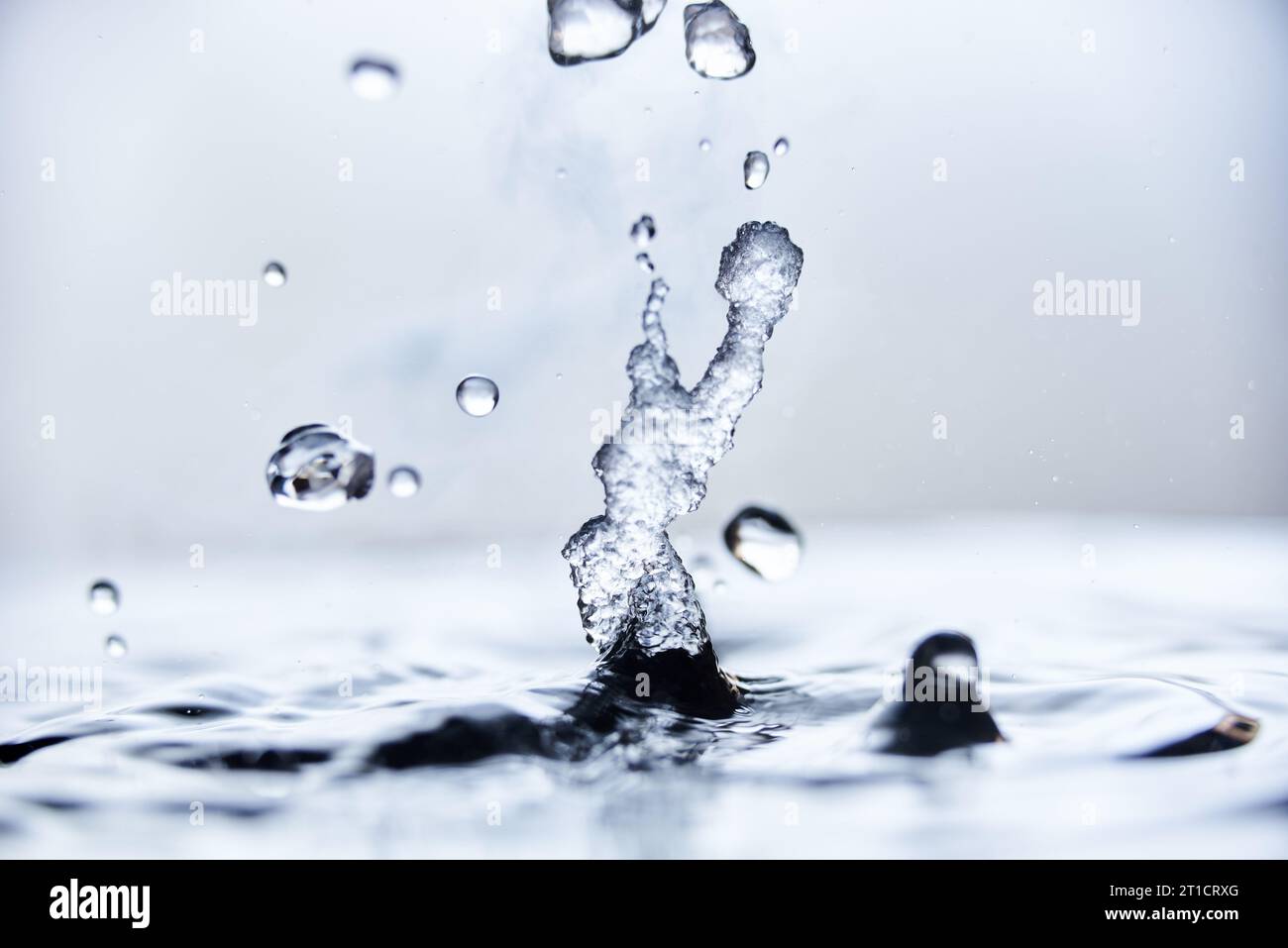 Boiling water splash with steam on blue background closeup Stock Photo ...