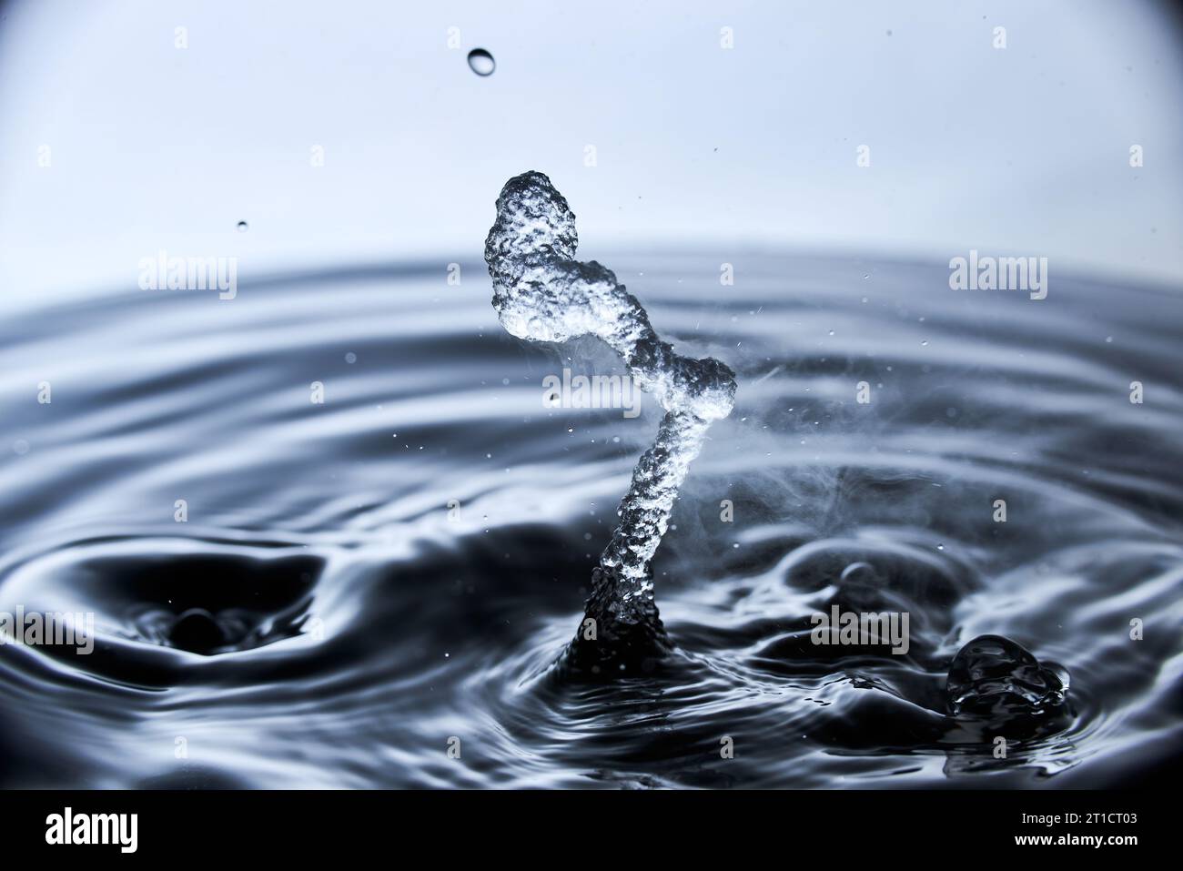 Boiling water splash with steam on blue background closeup Stock Photo ...
