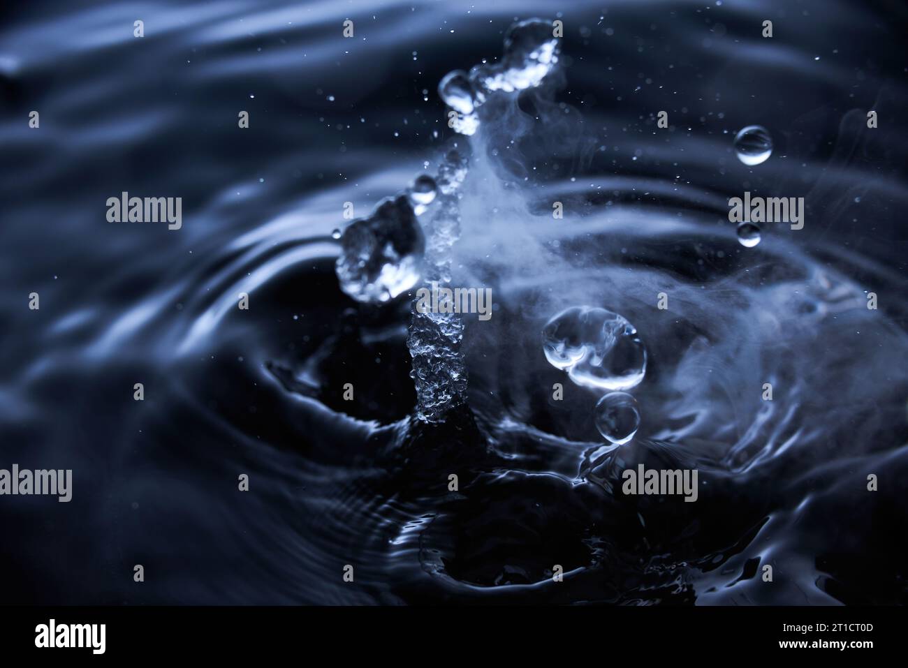 Boiling water splash with steam on dark blue background closeup Stock ...