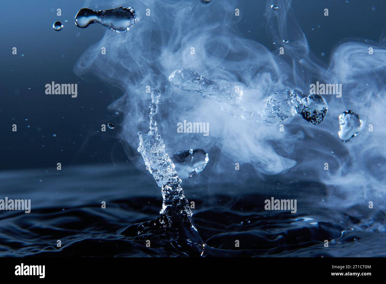 Boiling water splash with steam on dark blue background closeup Stock ...