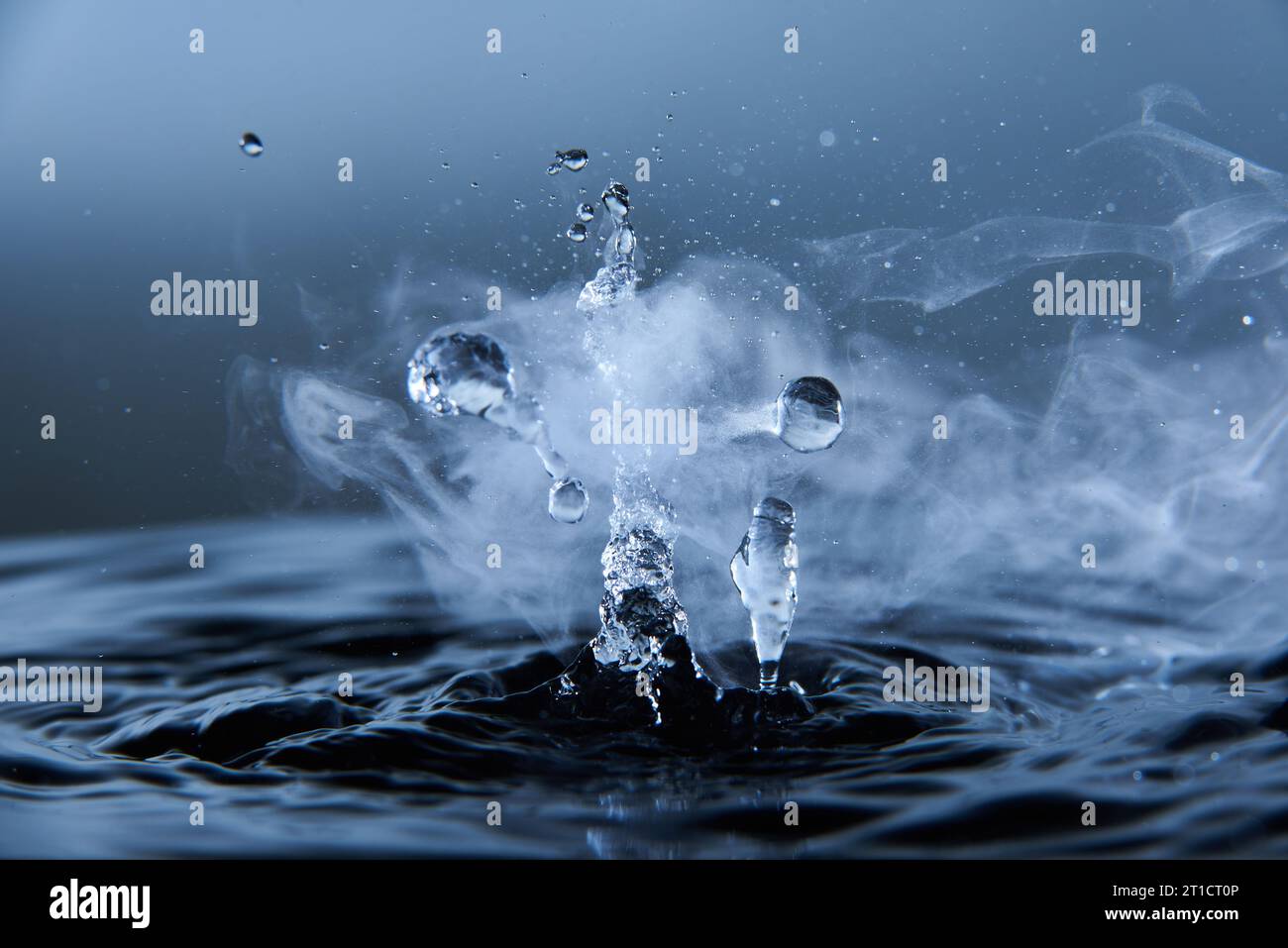 Boiling water splash with steam on dark blue background closeup Stock ...
