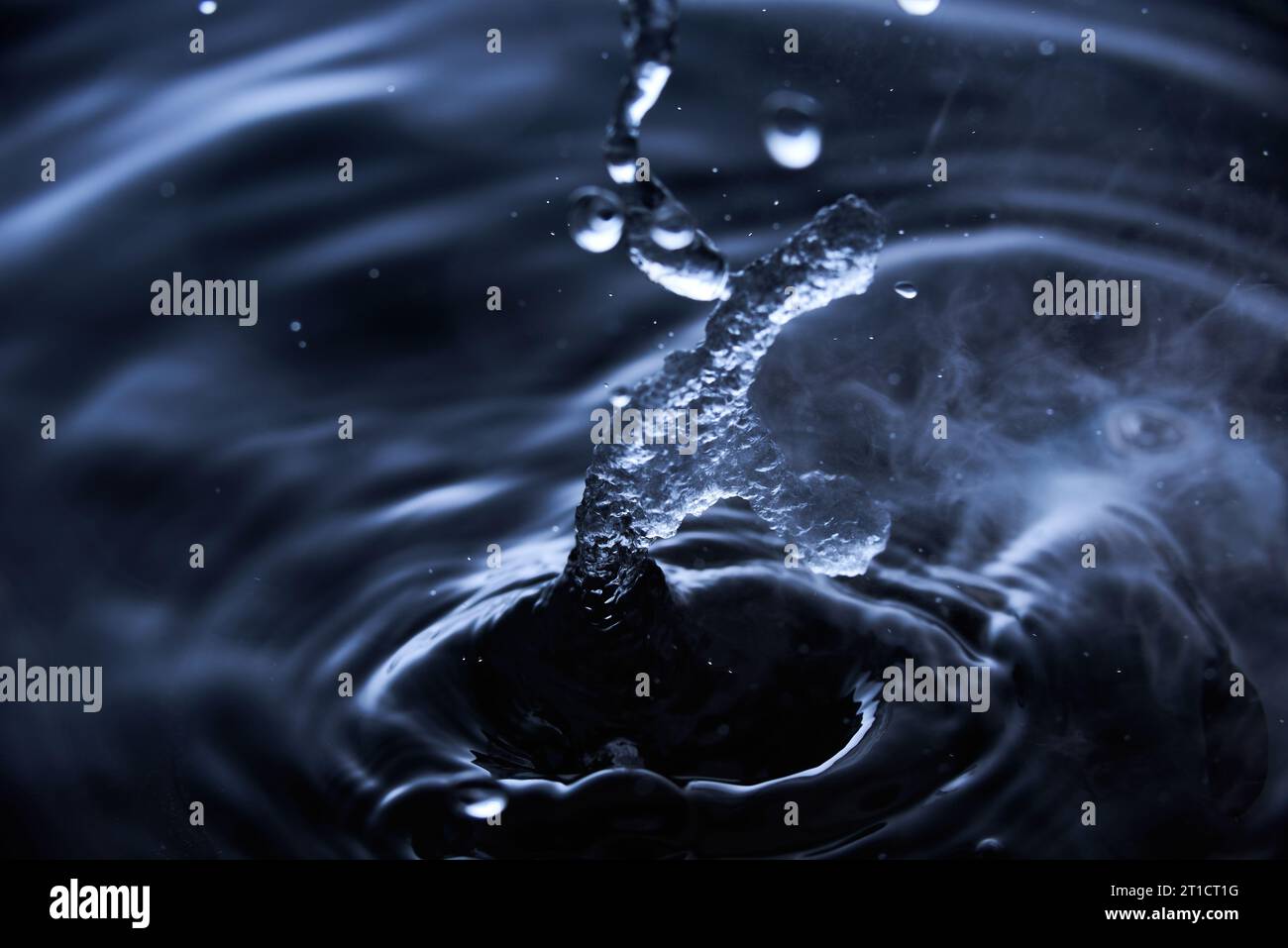 Boiling water splash with steam on dark blue background closeup Stock ...