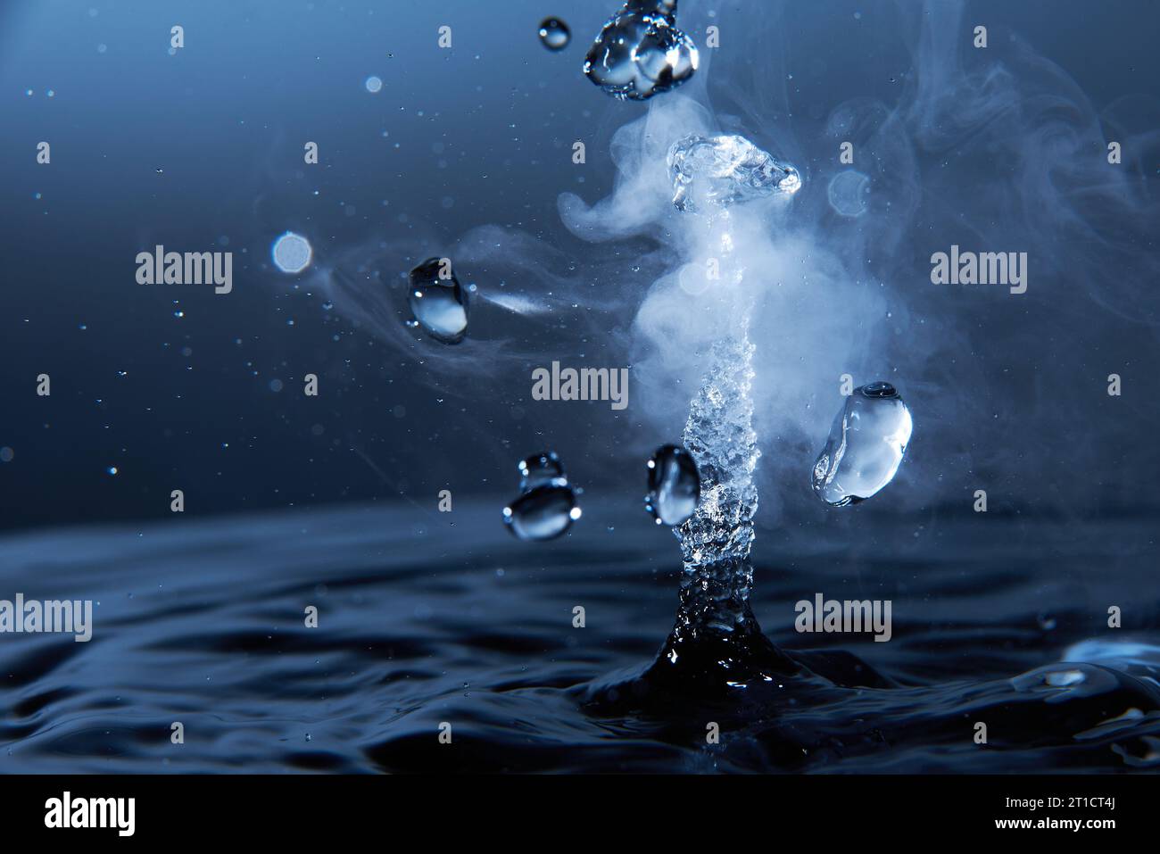 Boiling water splash with steam on dark blue background closeup Stock ...