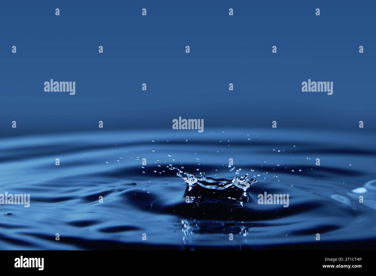 falling drop of water closeup on a dark blue background Stock Photo - Alamy