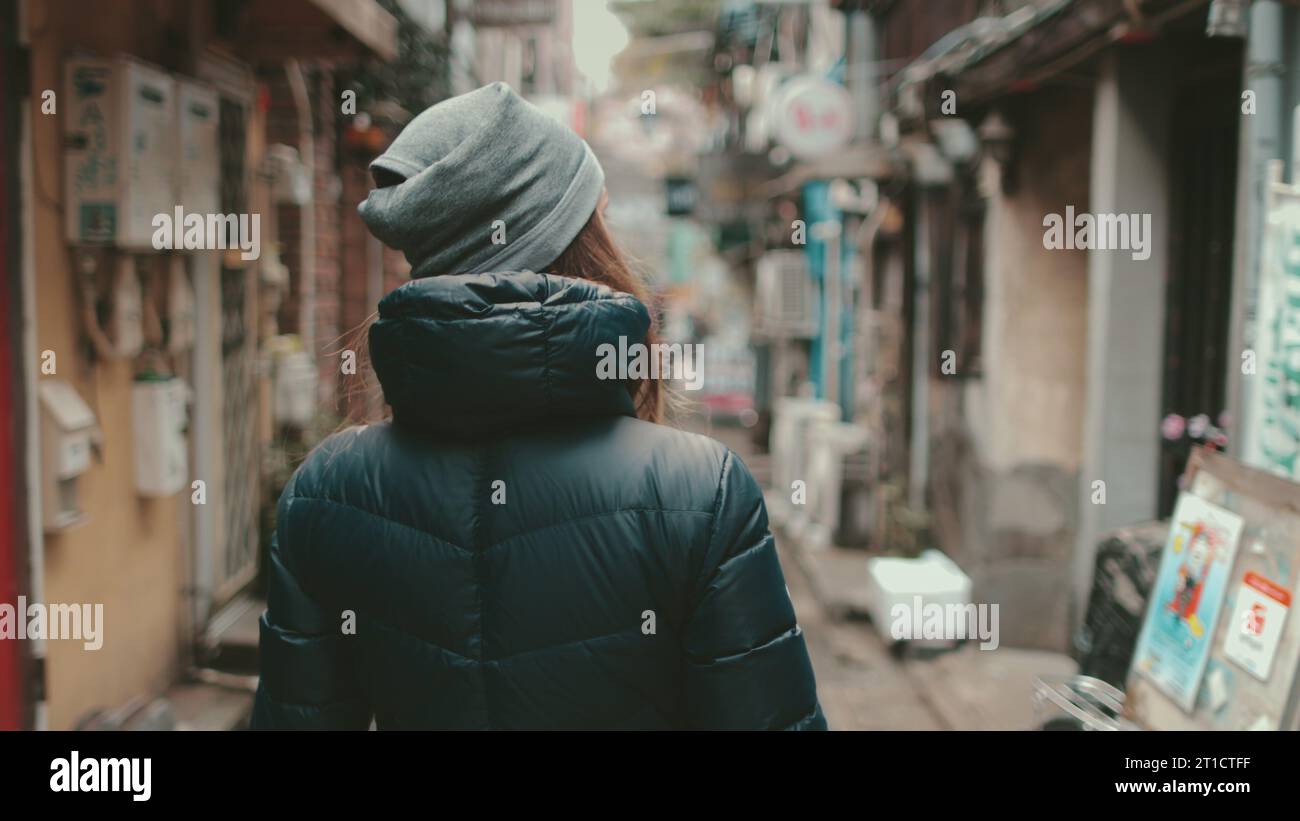 Tourist girl explore Japanese culture walking Golden Gai Tokyo streets ...