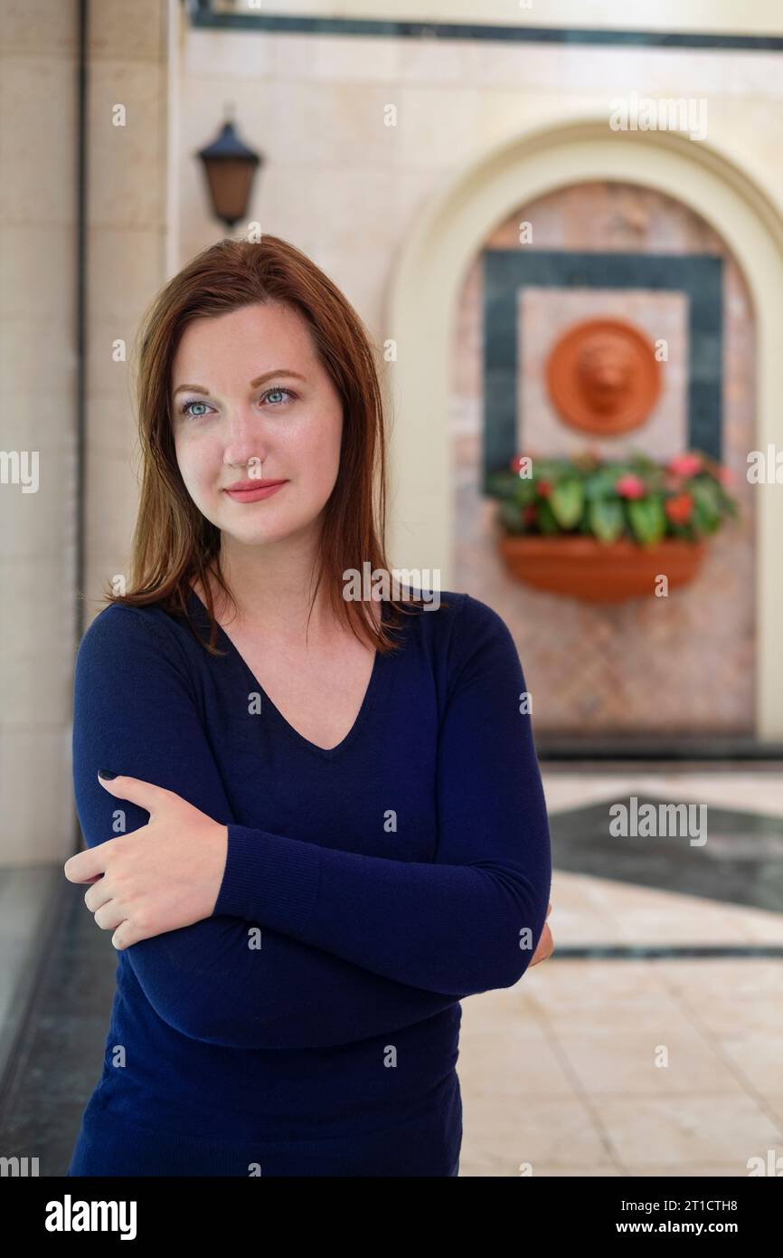 Portrait of a beautiful angelic Caucasian woman wearing a dark blue ...