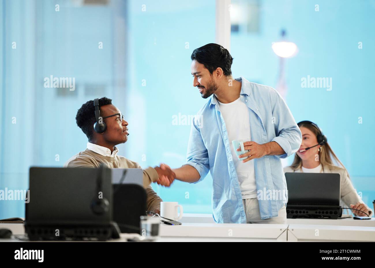 Call centre, man and handshake for teamwork in office for telecom ...