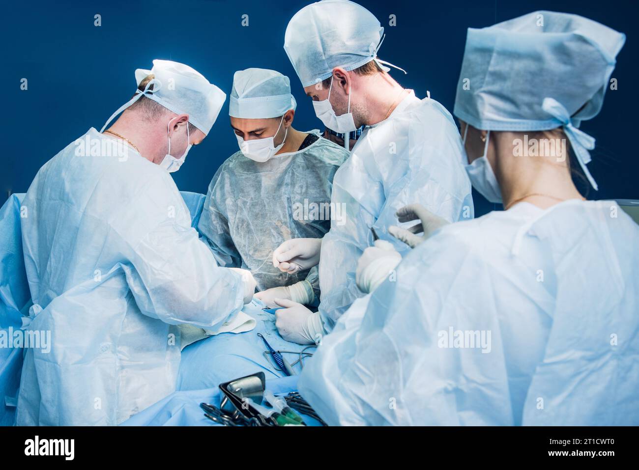 A team of surgeons performs a complex operation to remove a pancreatic ...