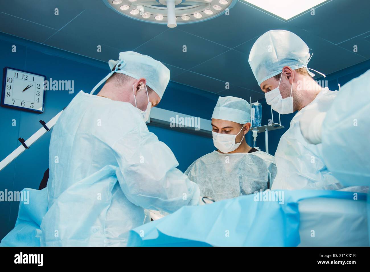 A team of surgeons performs a complex operation to remove a pancreatic ...