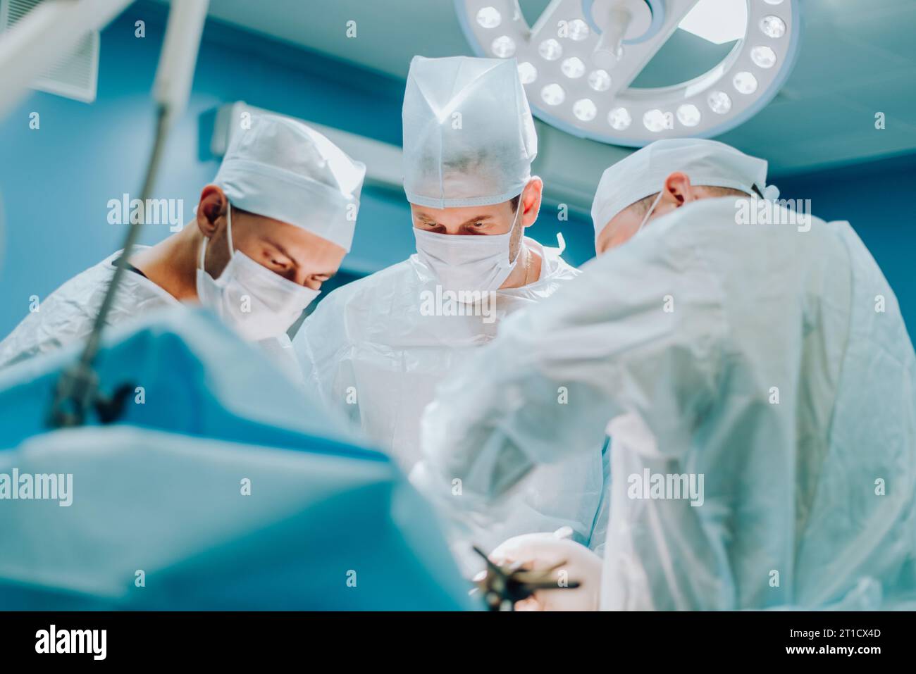 Male surgical team performs surgery hi-res stock photography and images ...