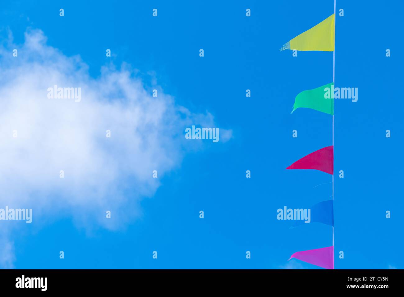 decorative colored pennants with a blue sky background and a cloud ...