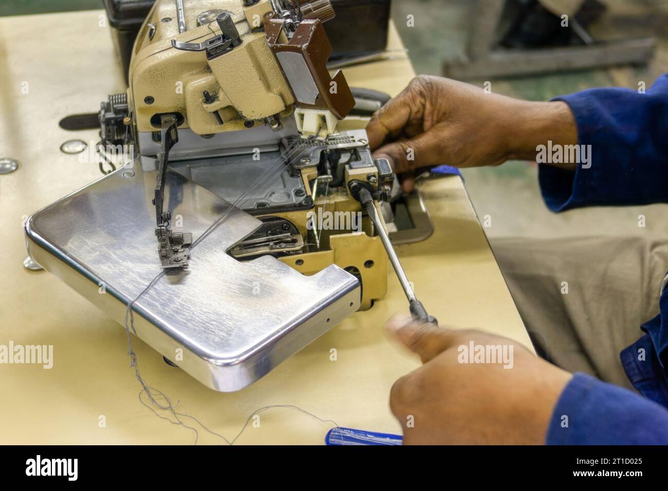 overlock machine repair african mechanic in textile industry, skilled ...