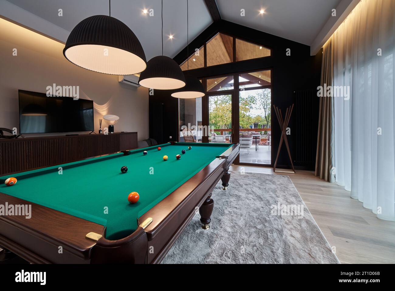 modern billiard room with a beautiful table and large windows. Nobody ...
