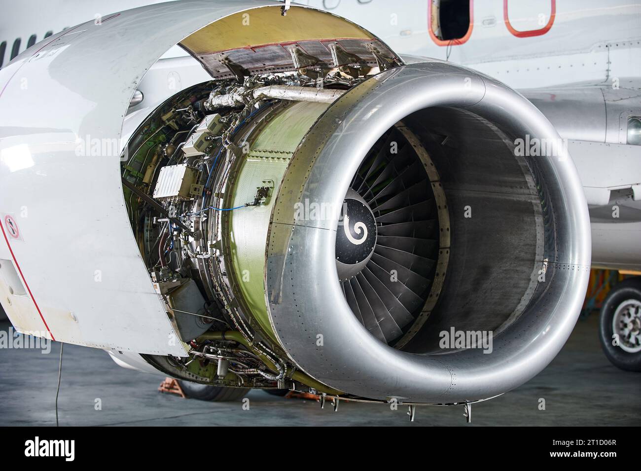 aircraft engine servicing - opened panels of a large engine of parked ...