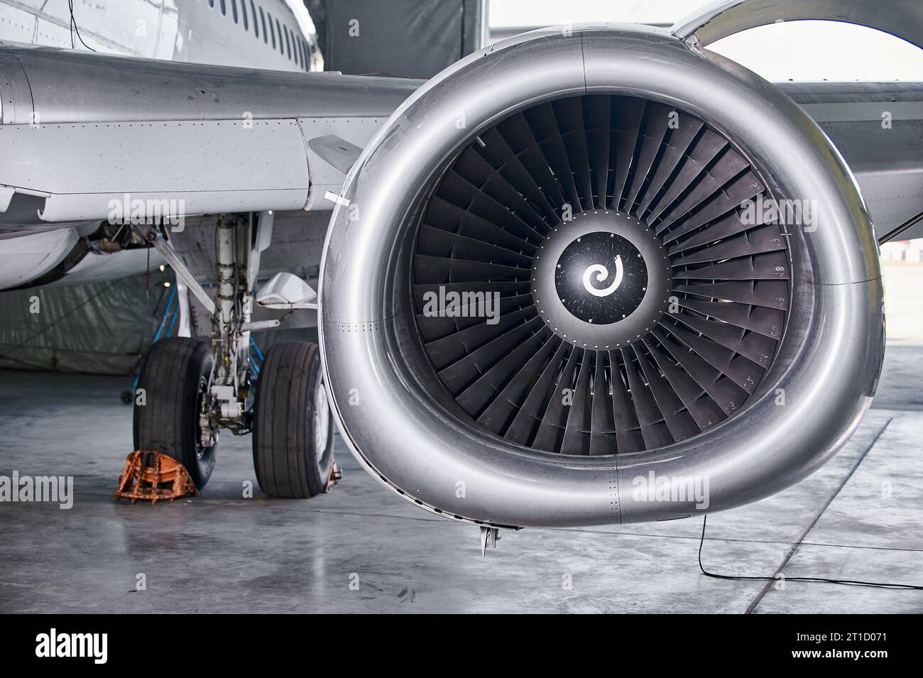 aircraft engine servicing - opened panels of a large engine of parked ...