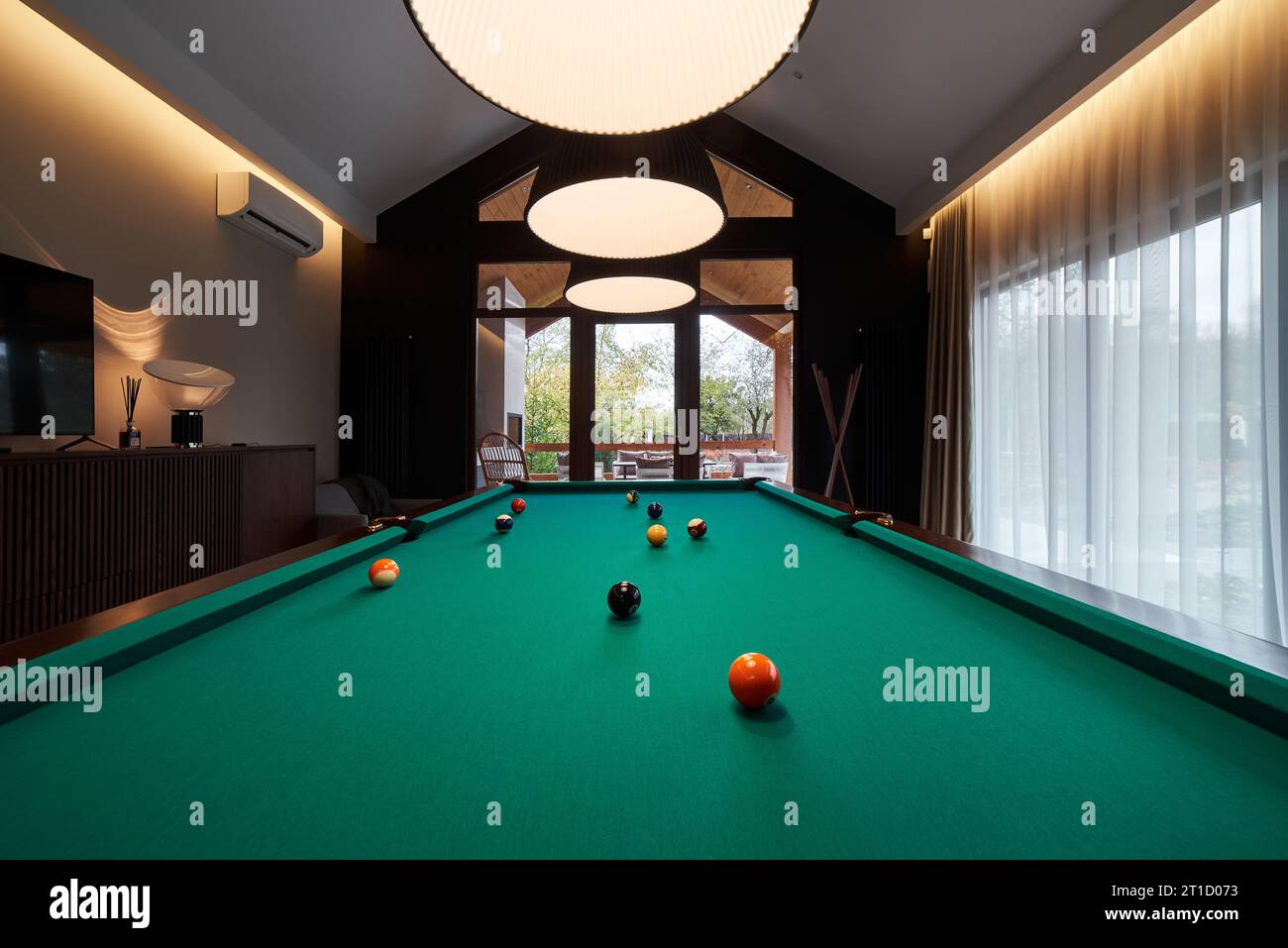 modern billiard room with a beautiful table and large windows. Nobody ...
