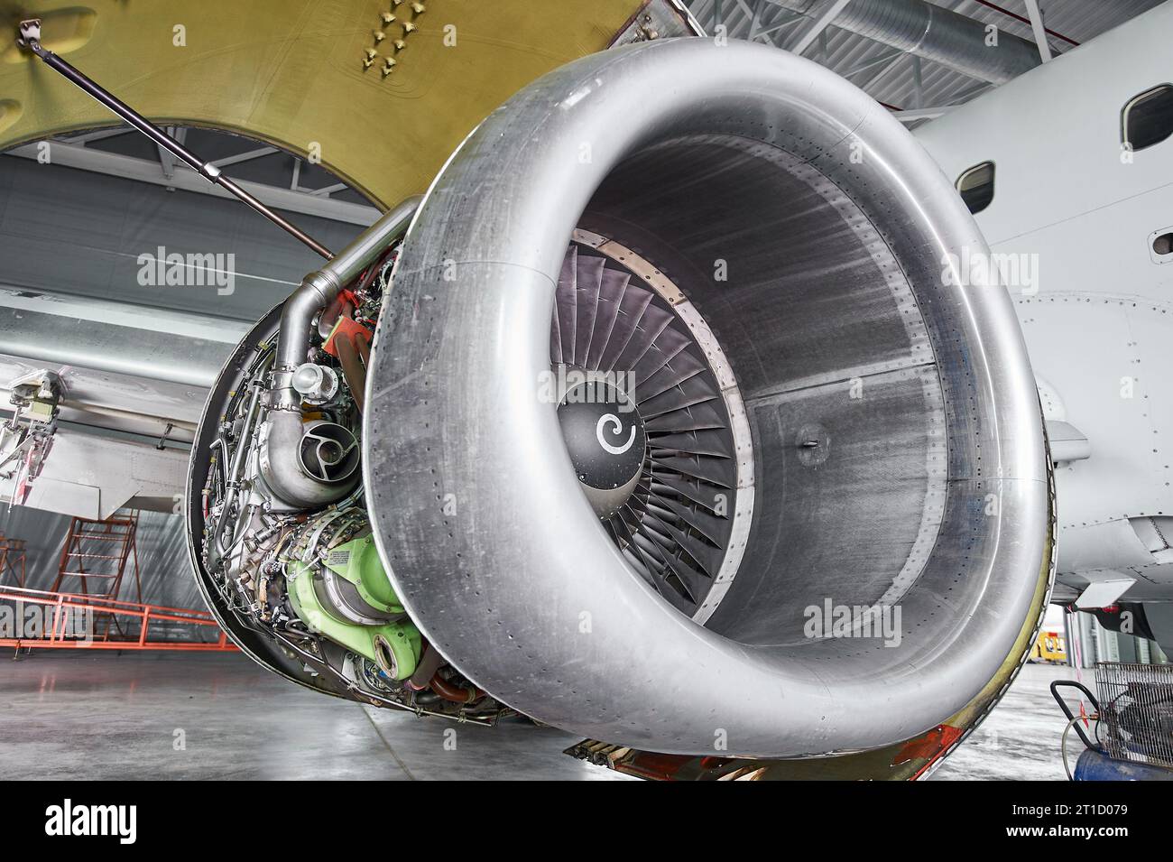 aircraft engine servicing - opened panels of a large engine of parked ...