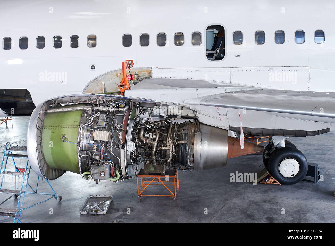 aircraft engine servicing - opened panels of a large engine of parked ...