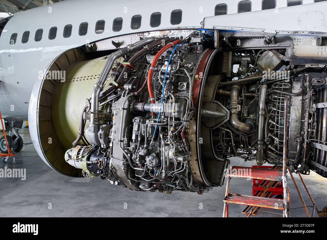 aircraft engine servicing - opened panels of a large engine of parked ...