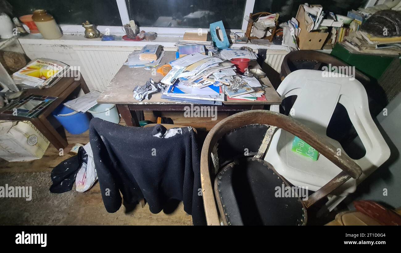 Every corner is a pile of clutter and the jumper hanging off the back ...