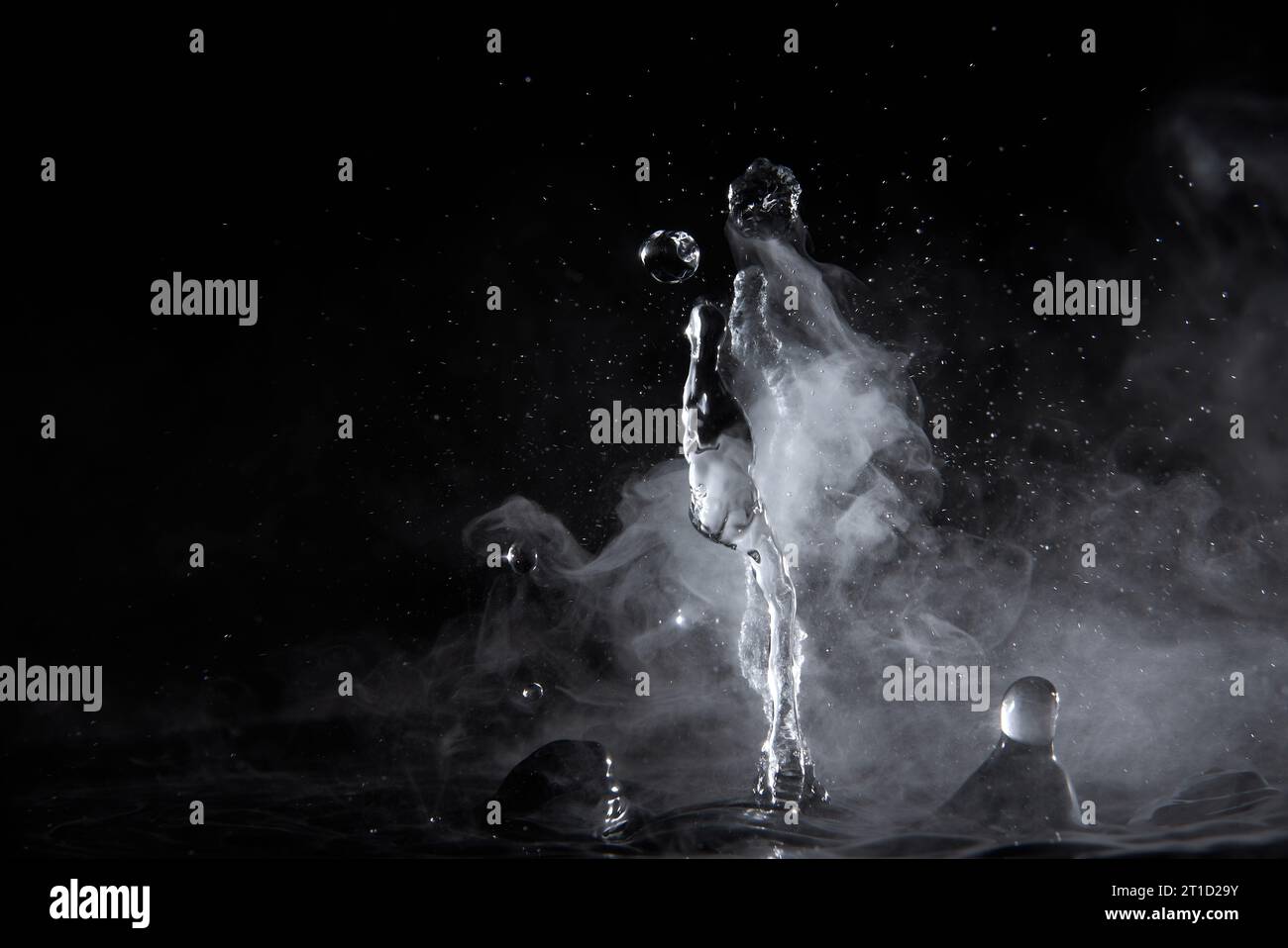 Boiling water splash with steam on black background closeup Stock Photo ...