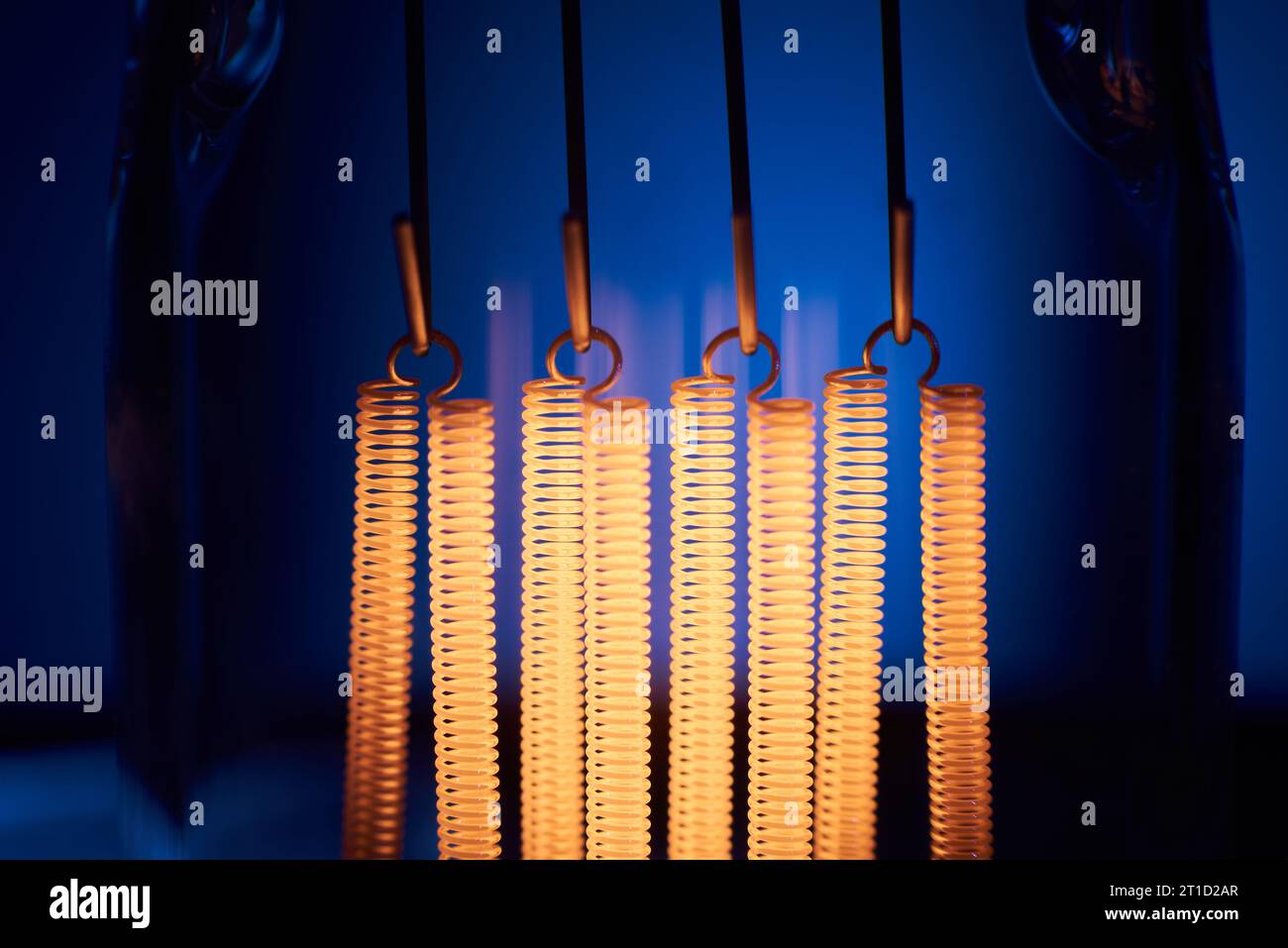 Electric vintage Edison light bulb with a spiral on a blue background ...