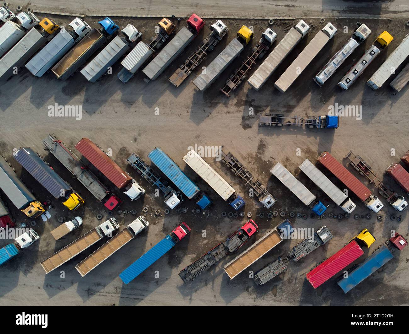 aerial view of a parking lot of trucks ready for loading containers and ...