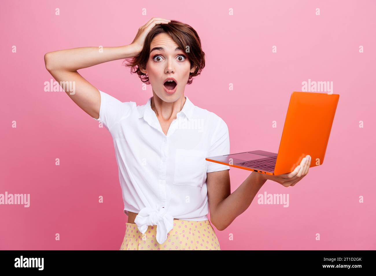 Photo of young girl staring speechless at you holding computer touching ...