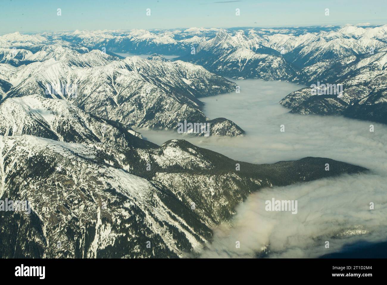 Aerial view of mountains of North Cascades rising above clouds ...