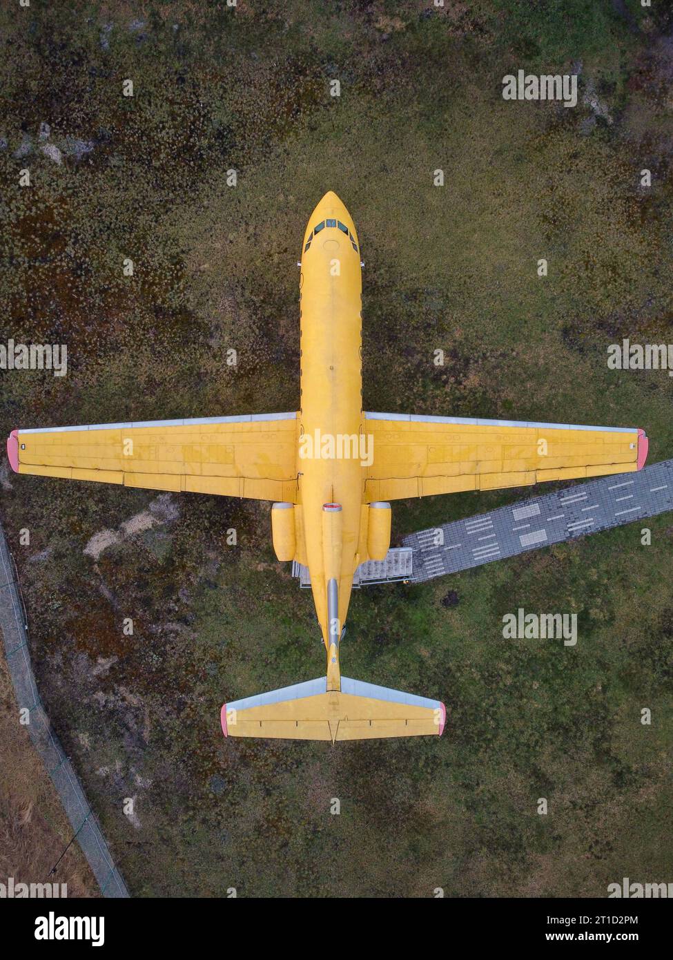 aerial view from drone of a small old jet yellow passenger plane ...